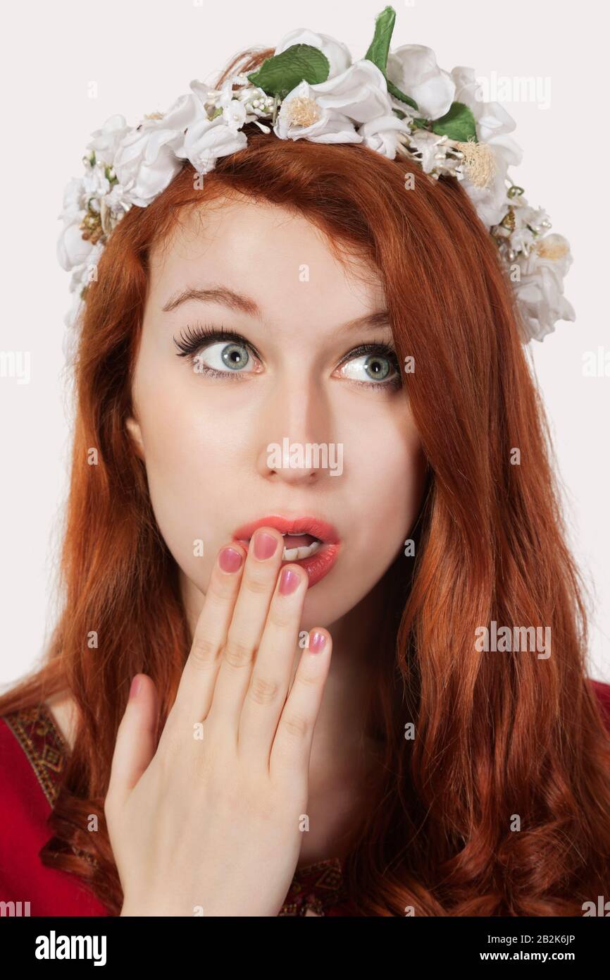 Shocked young woman in old-fashioned princess costume looking away ...