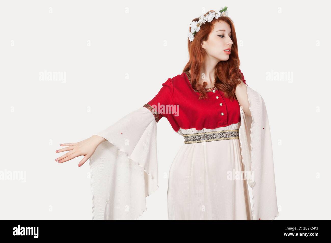 Sad young woman in old-fashioned princess costume looking away against ...