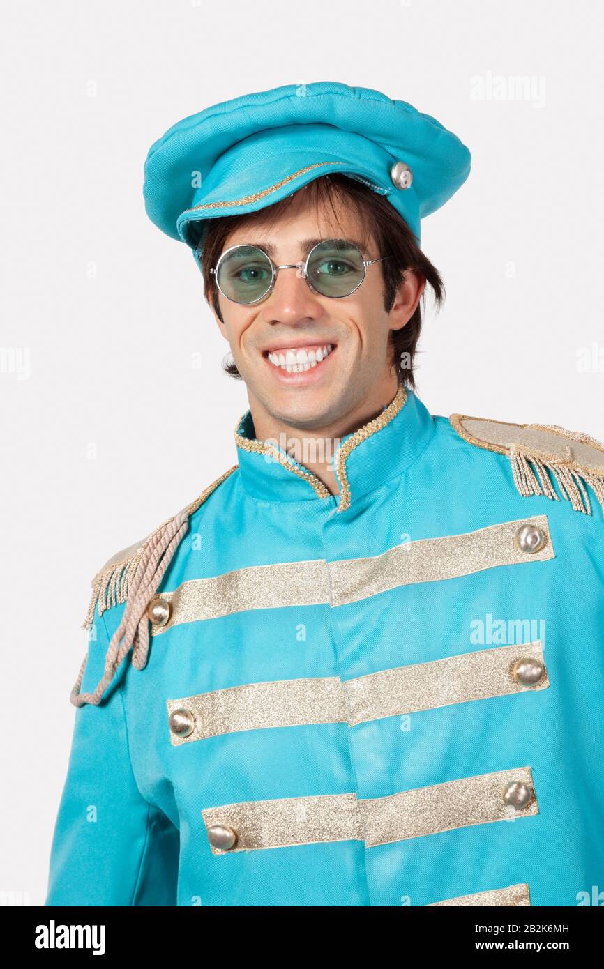 Portrait of young male marching band member in blue costume smiling ...
