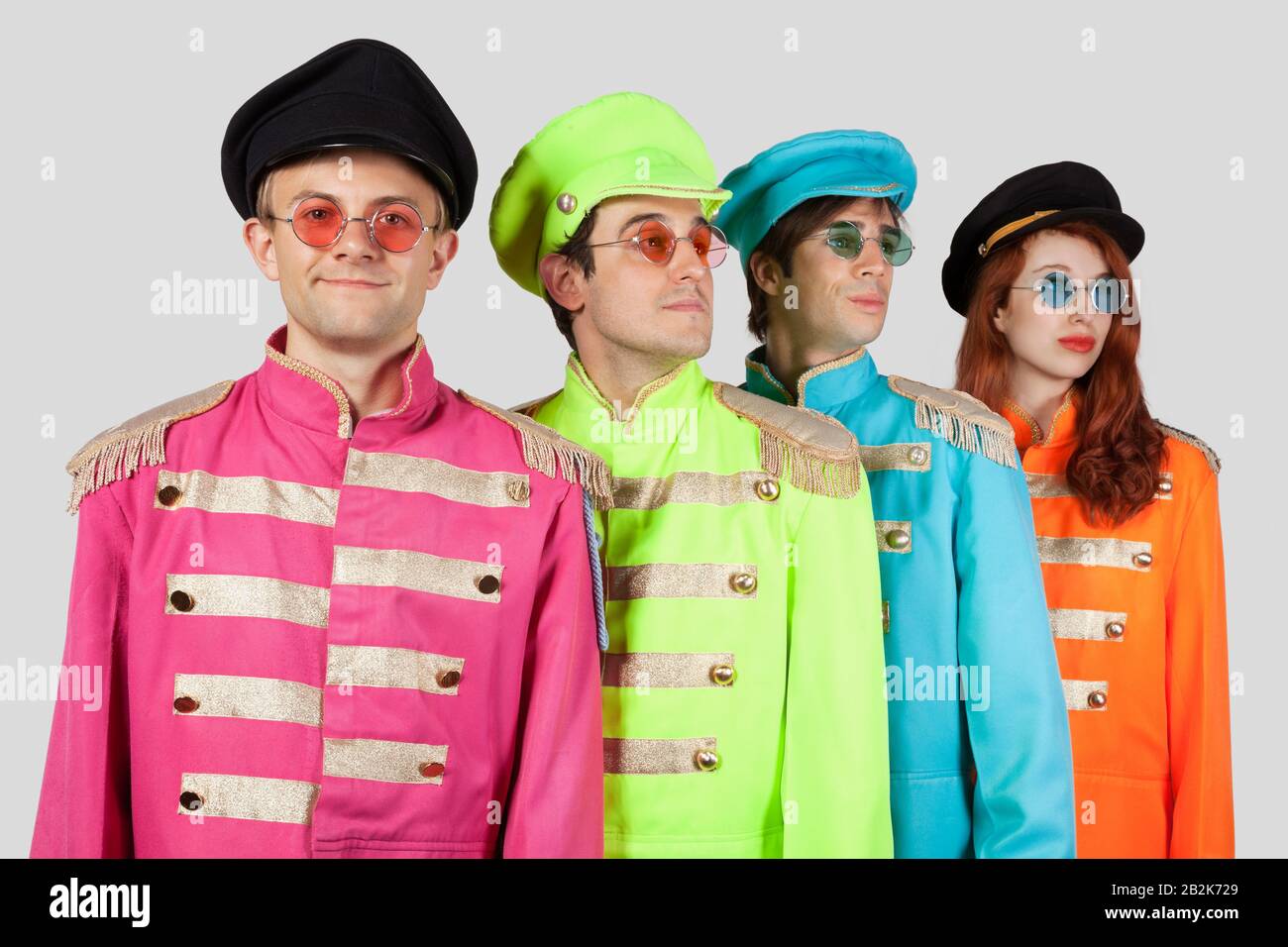 Marching band members in colorful clothing against gray background ...