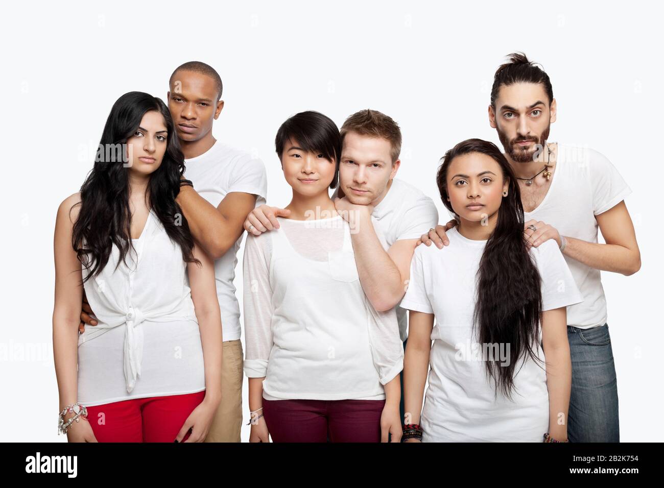 Portrait three young couples standing together over white background ...
