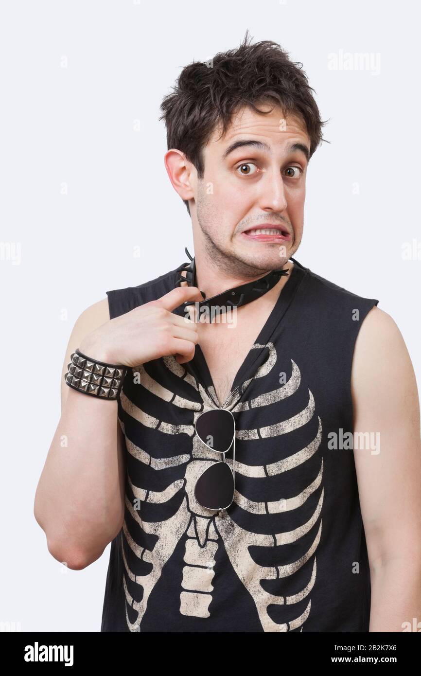 Portrait of displeased young punk man over white background Stock Photo ...