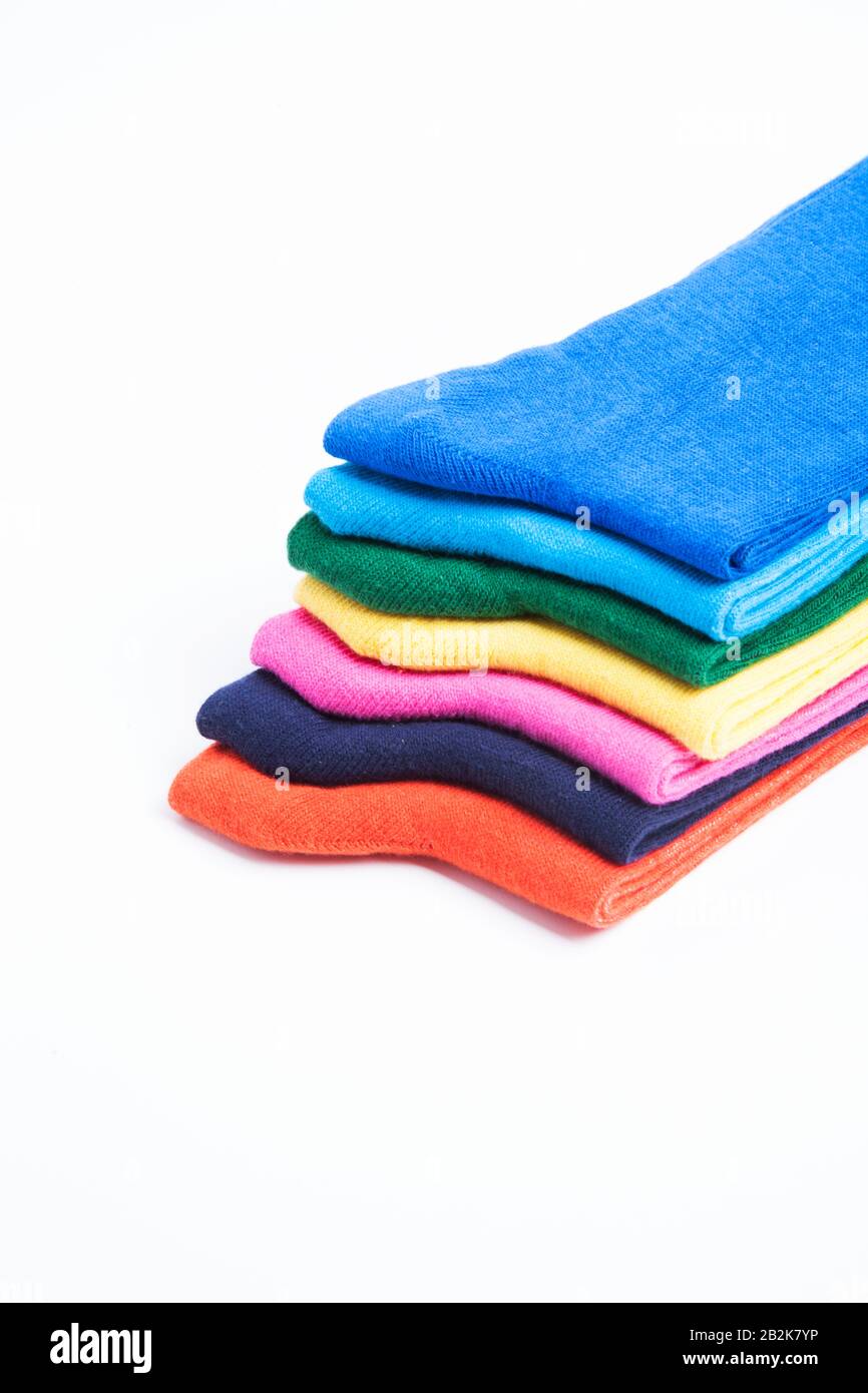 Colorful stack of folded socks over white background Stock Photo - Alamy