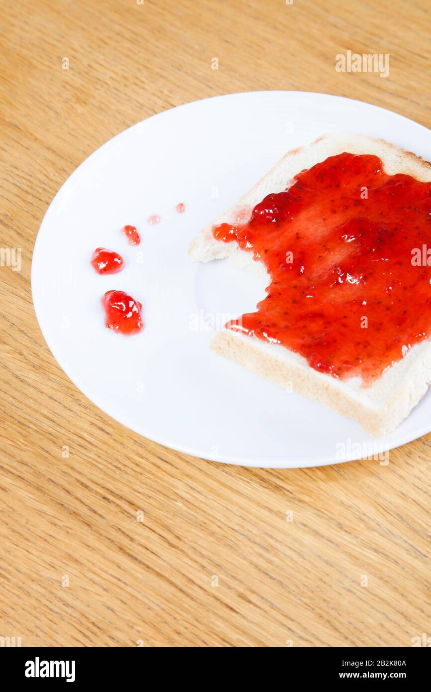 Close-up of jam spread on slice of bitten bread Stock Photo - Alamy