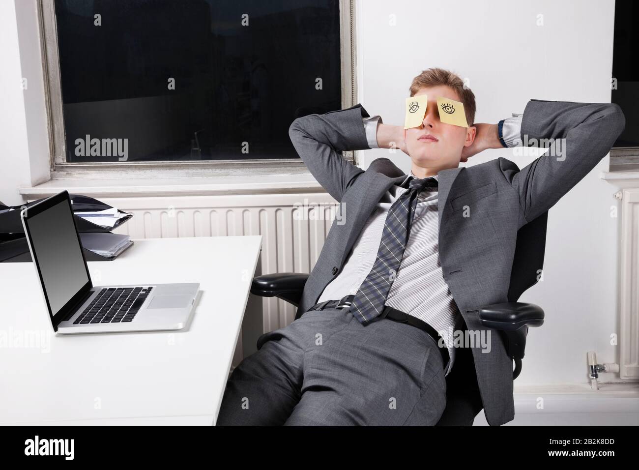 Businessman sleeping with sticky notes on eyes in office Stock Photo ...