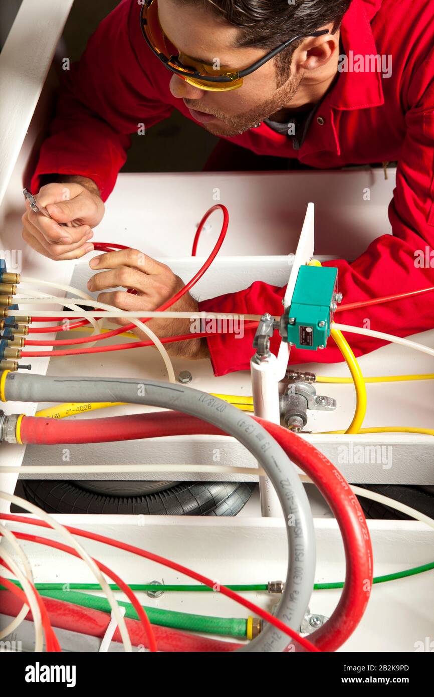 Technician inspecting colorful wiring circuit Stock Photo - Alamy