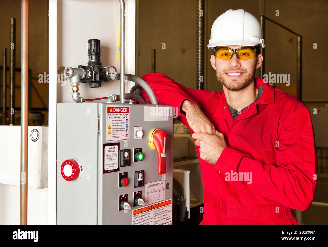 Technician standing next to electrical unit Stock Photo - Alamy