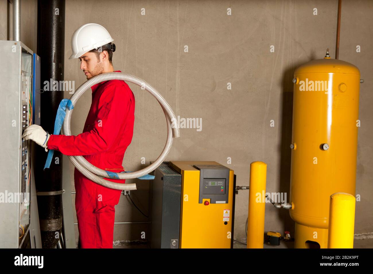 Technician operating heavy duty machinery in manufacturing plant Stock ...