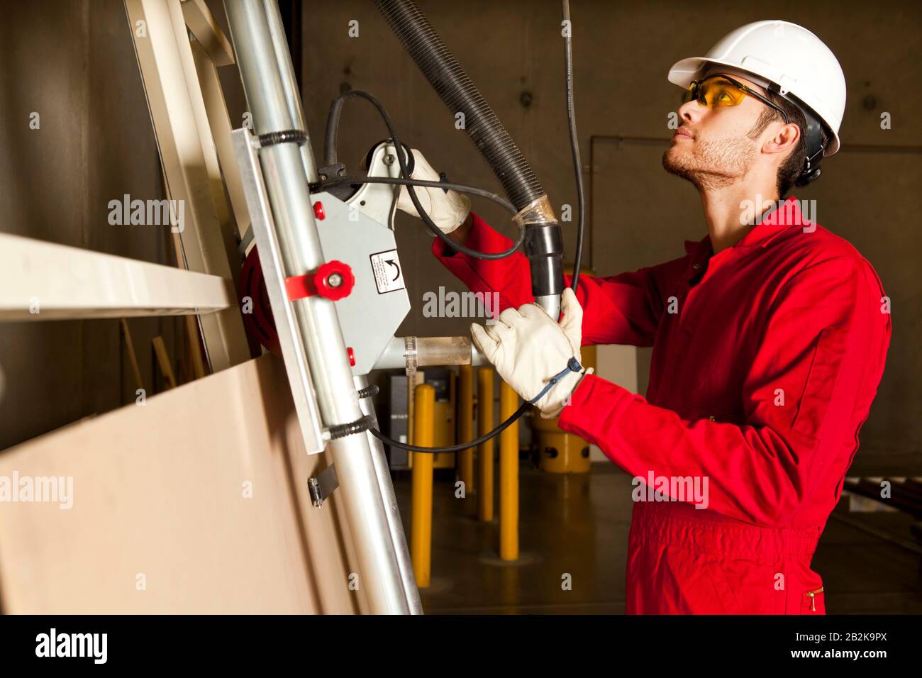 Technician operating heavy duty machinery in manufacturing plant Stock ...