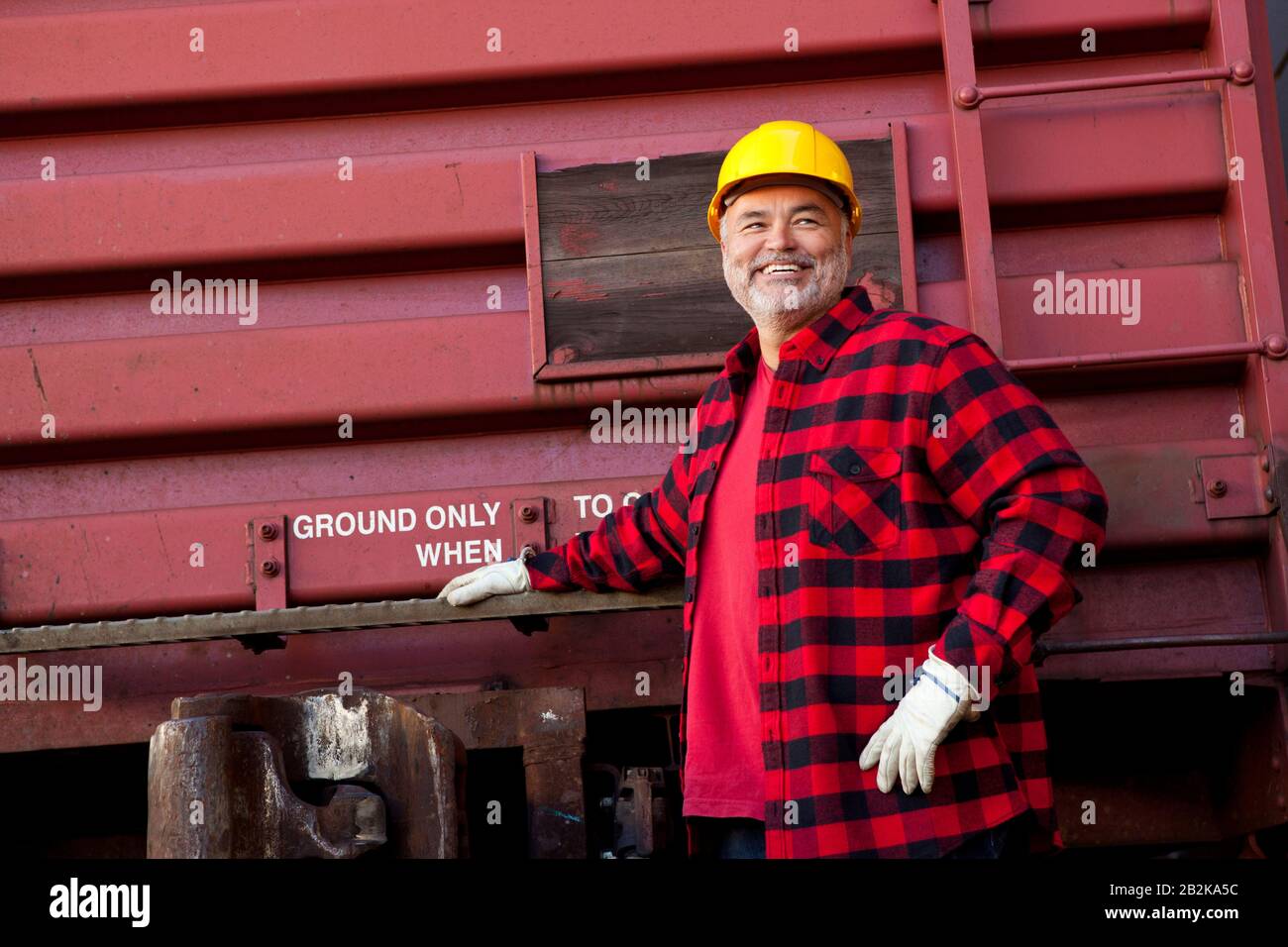 Middle Aged worker standing in industrial railway carriage Stock Photo ...
