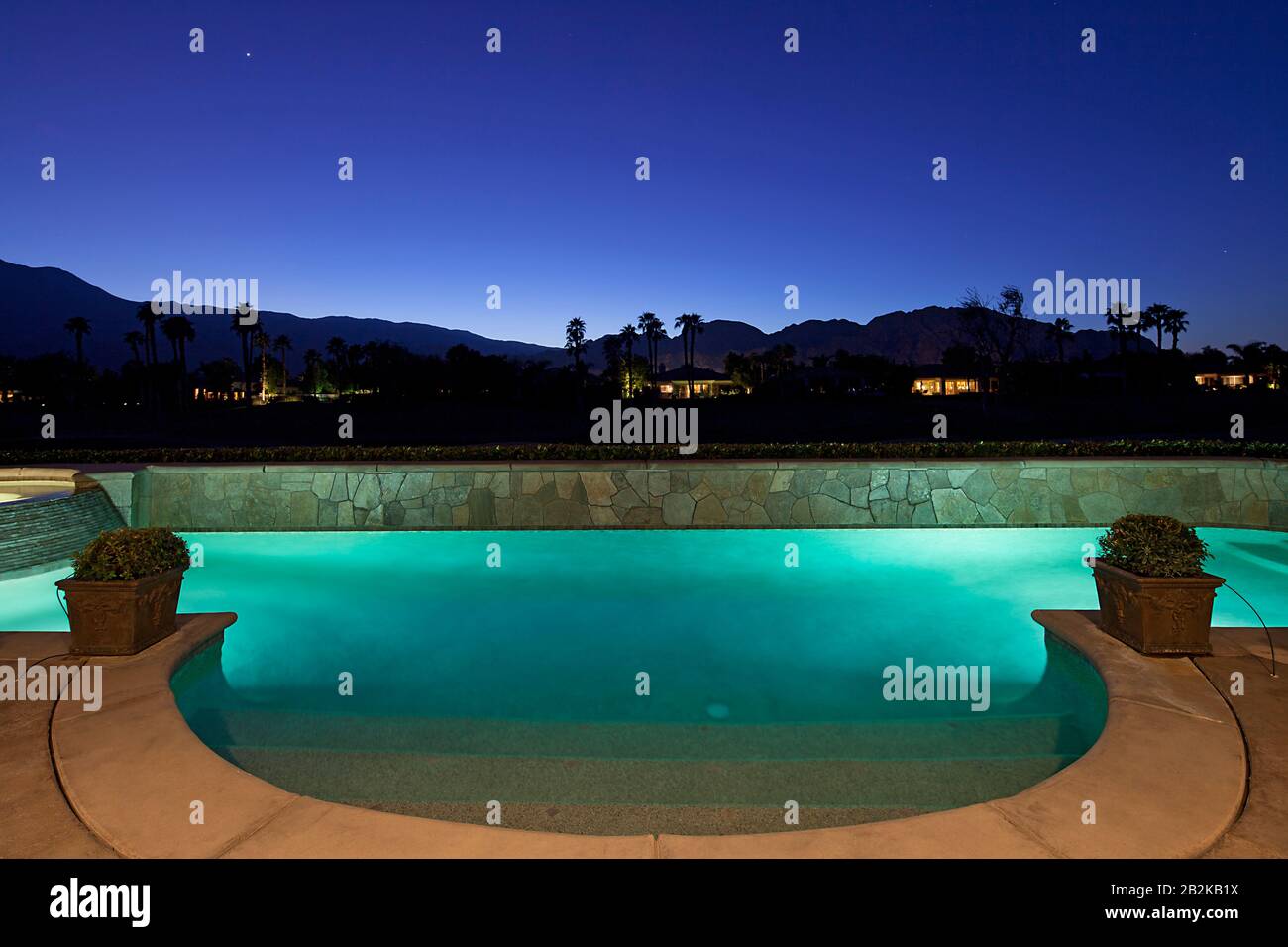 Pool lit from underneath at dusk Stock Photo - Alamy