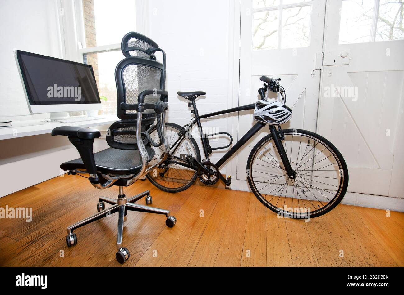 PC, Desk and Bicycle inside an office Stock Photo - Alamy