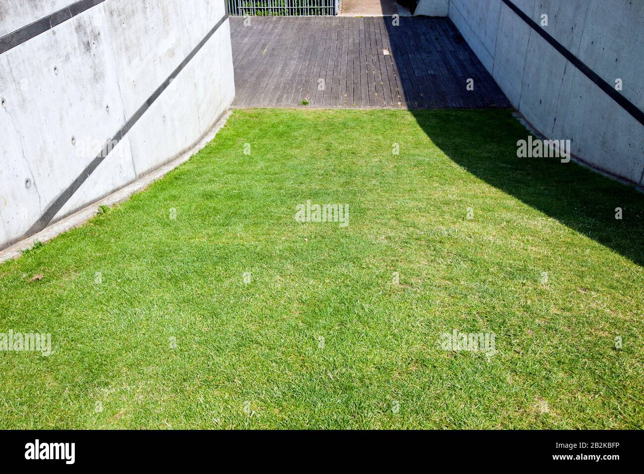 Grass verge between two brick walls Stock Photo - Alamy