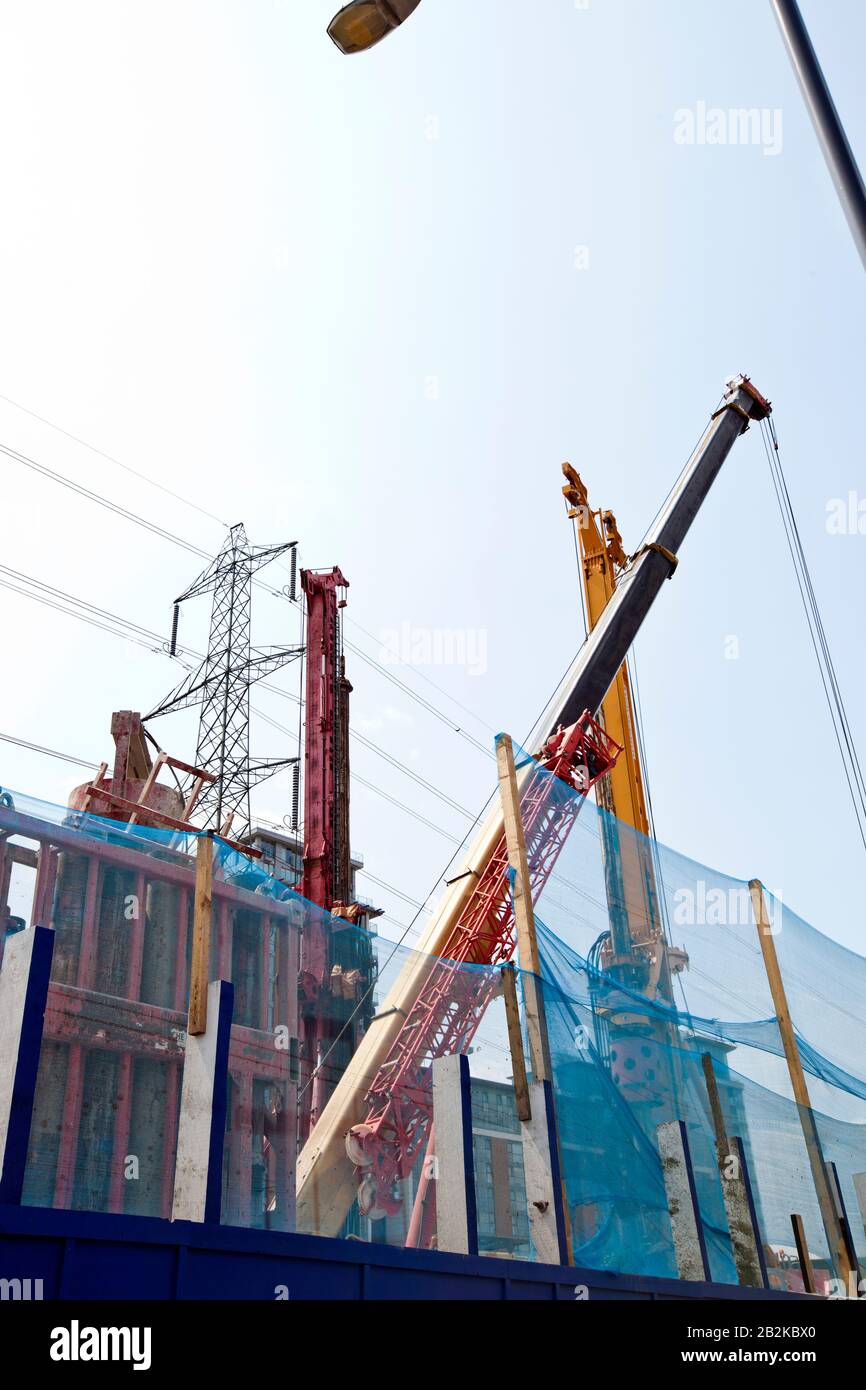 Heavy machinery digging foundations on building site Stock Photo - Alamy