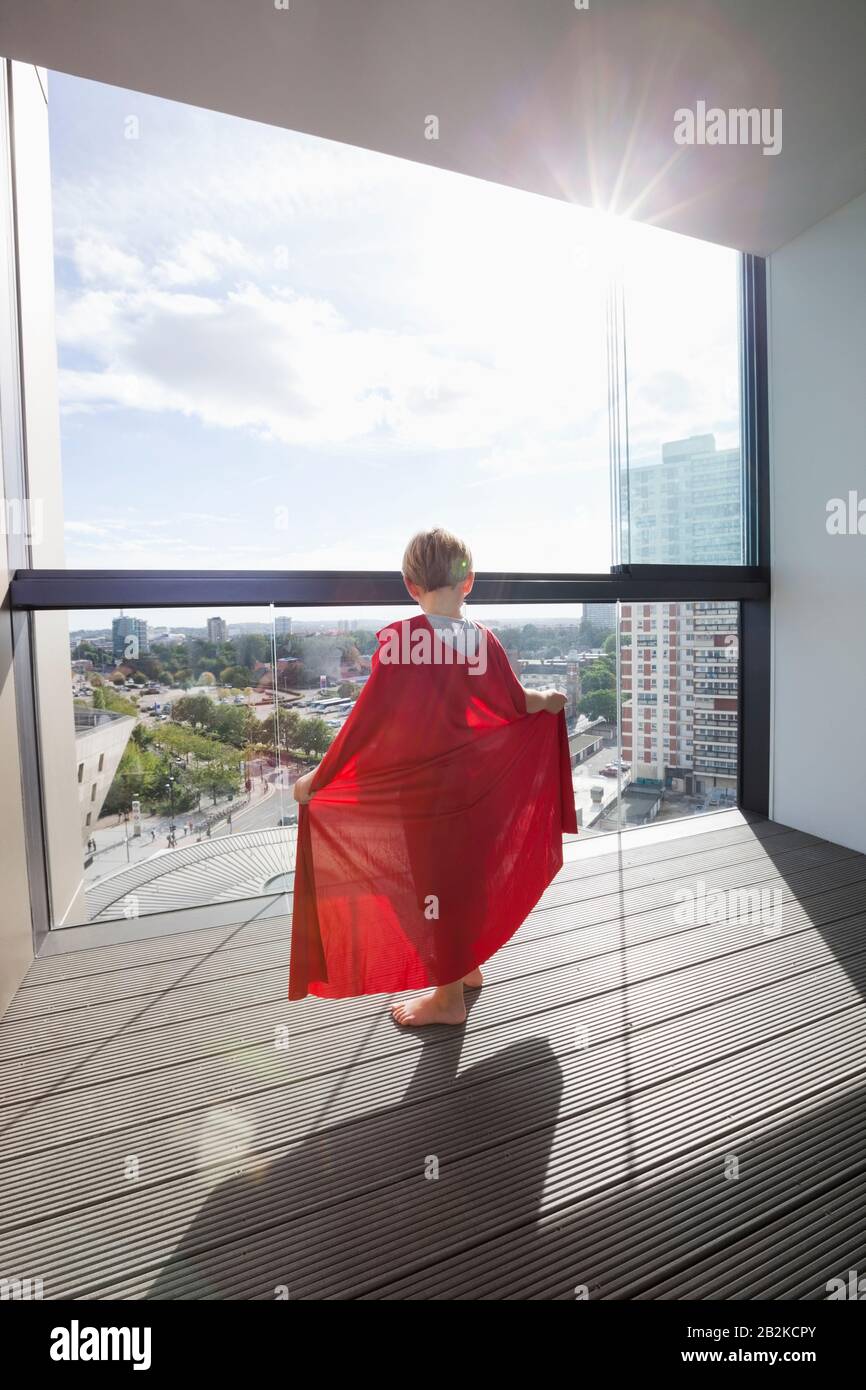 Rear view of boy in superhero costume at home Stock Photo - Alamy