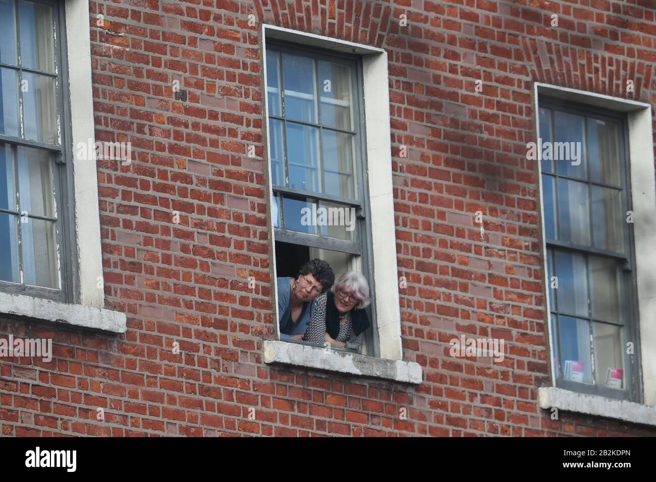 People looking out of a window waiting the arrival of the Duke and ...