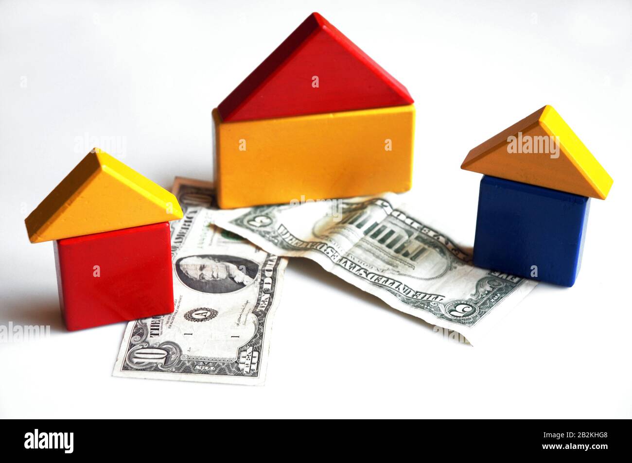 Housing money cash symbol colorful wood house bricks Stock Photo - Alamy