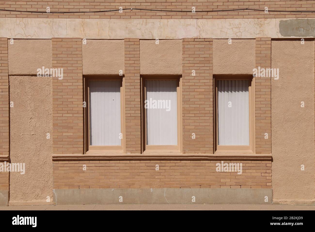 a set of retro old windows in a brown brick warehouse office building ...
