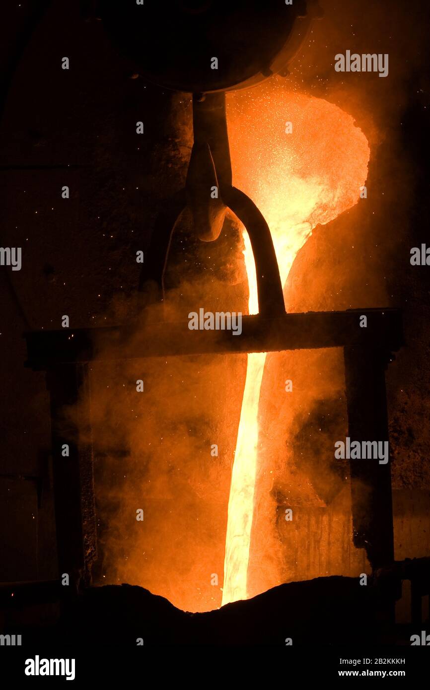 Molten Iron Flowing From The Smelter Pot Stock Photo - Alamy