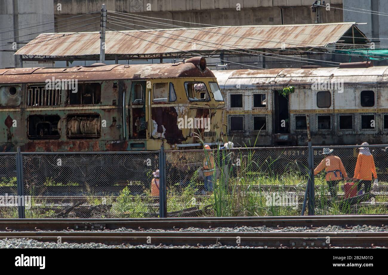 Workers work in railway depot. Old rusty trains on rails in the city ...