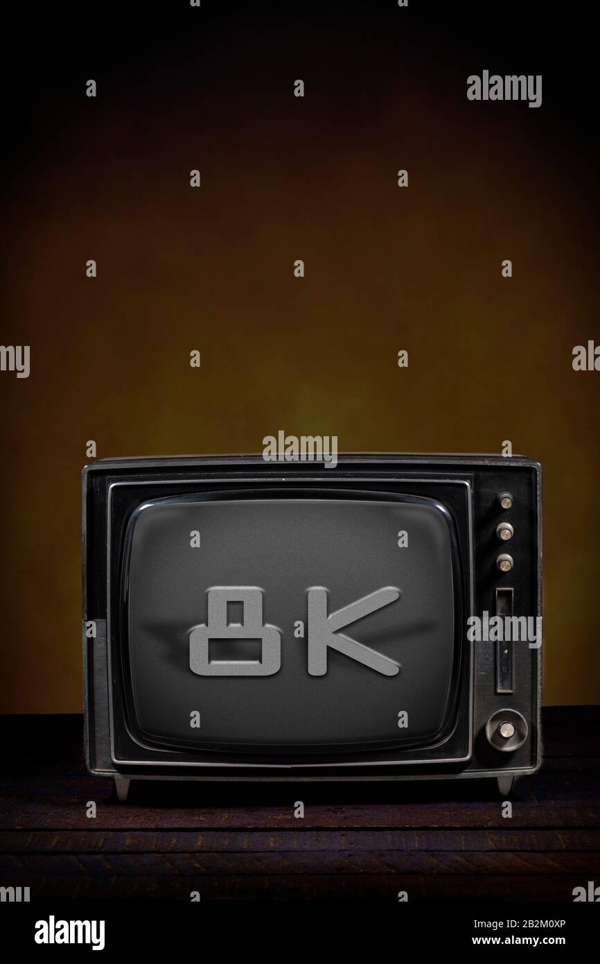 Old portable television, with text on the screen. Wooden table and ...
