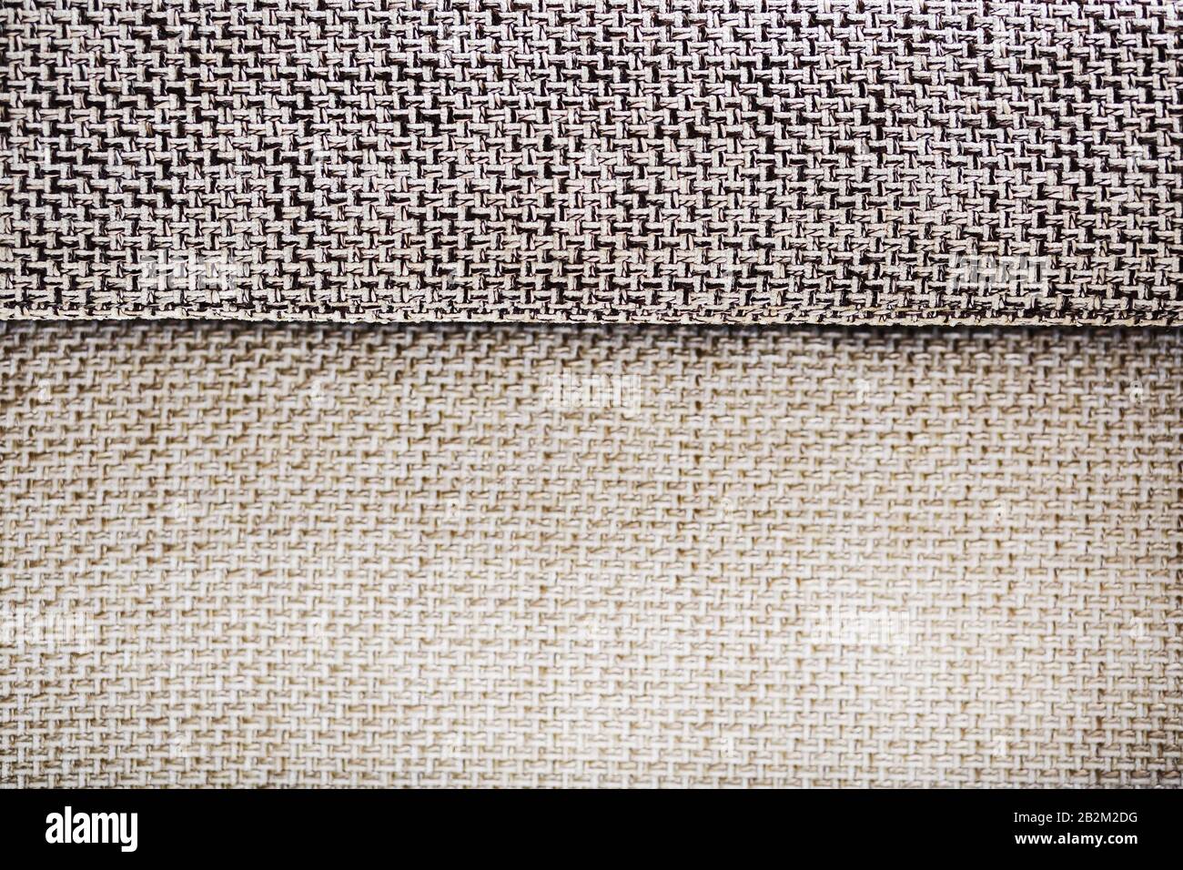 Closeup of a fragment of a beige textile sofa in the room. Texture of ...