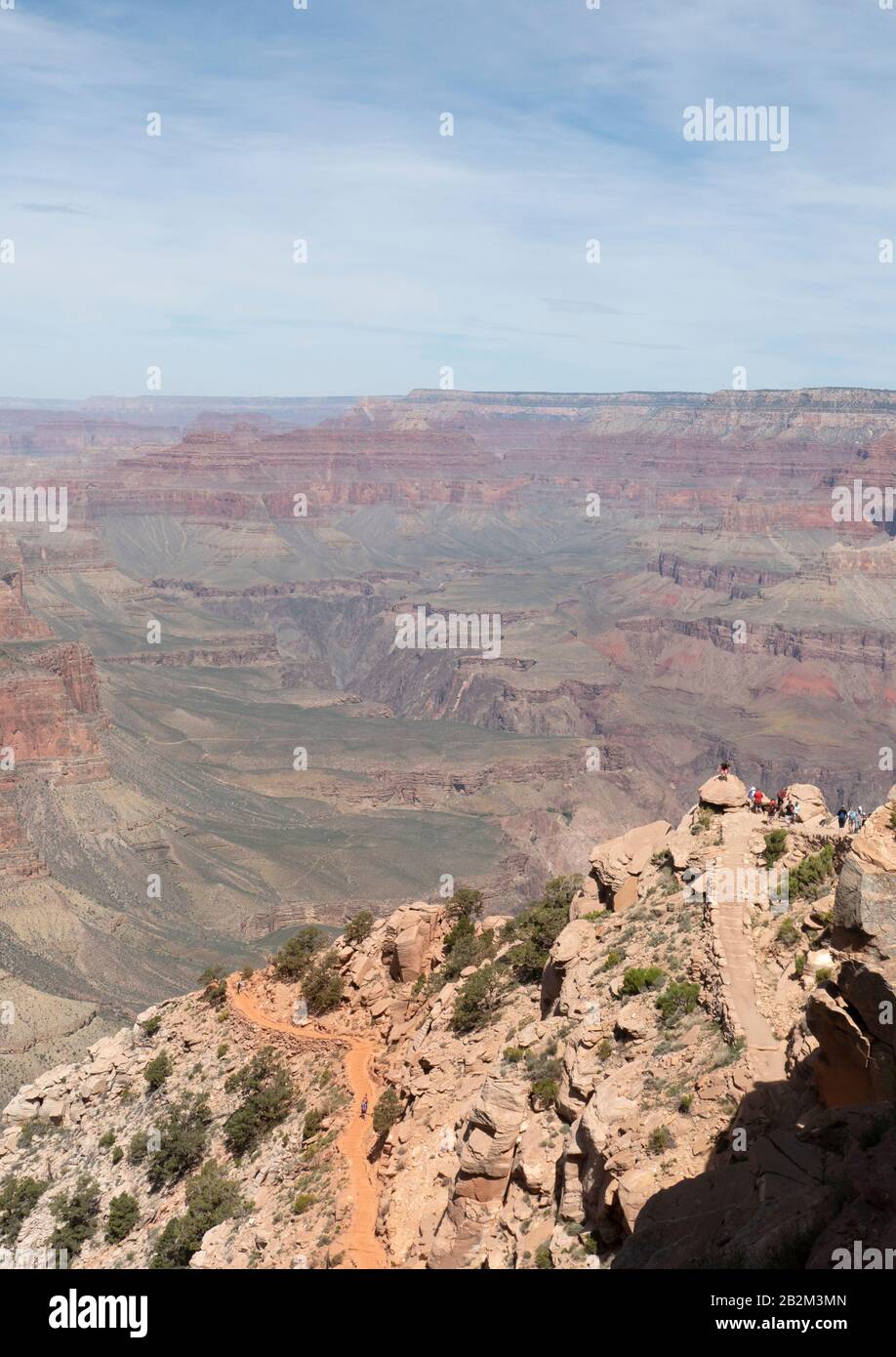 Tourists walk down a cliff path towards the Colorado River in the Grand ...