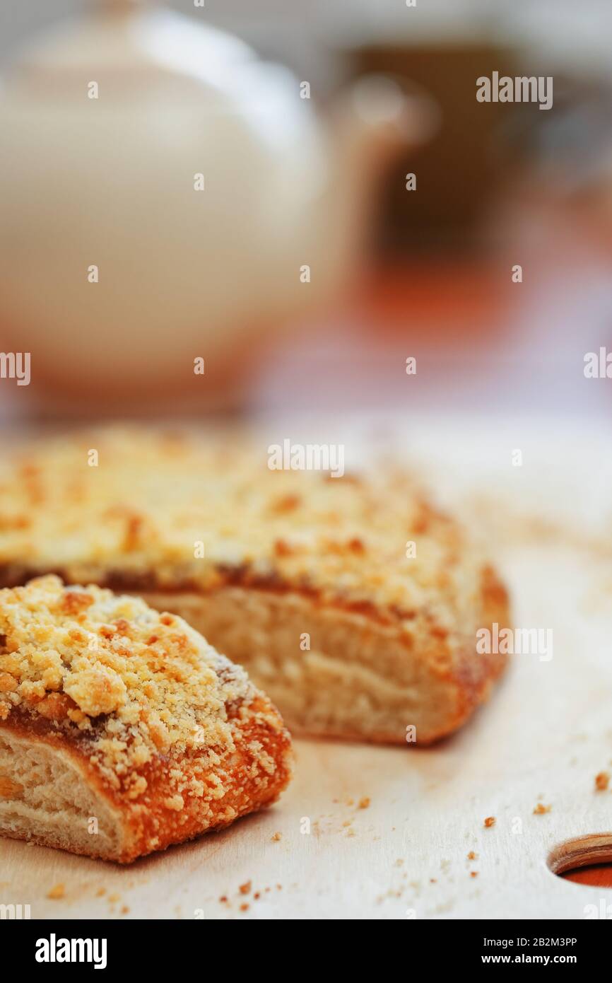 Sweet sand tart with apricot jam. Cut into pieces, lying on a board ...