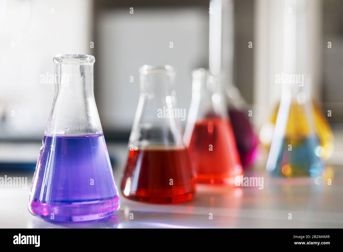 Chemical laboratory flask with blue purple-pink liquid stand on the ...