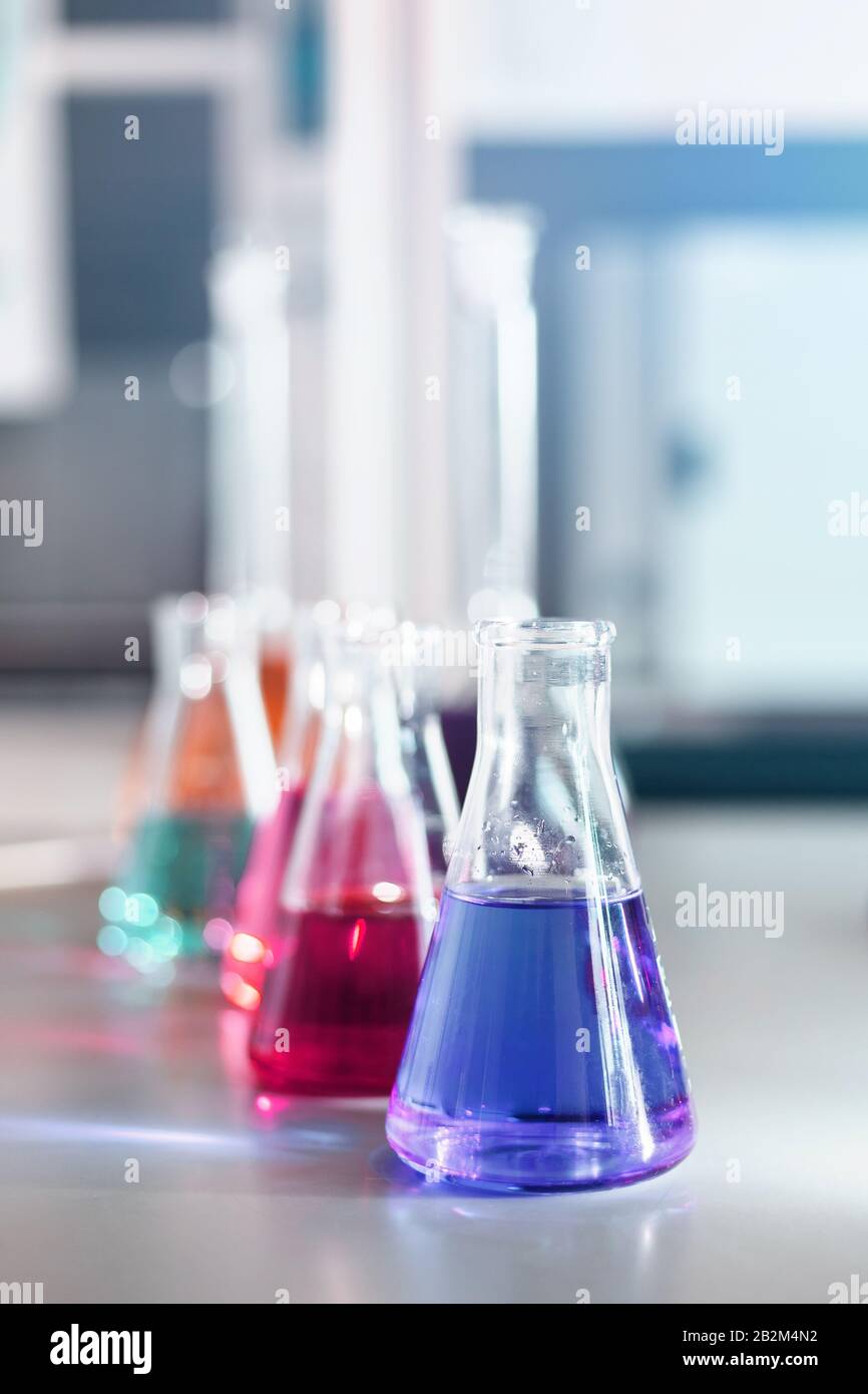 Chemical laboratory flask with blue purple-pink liquid stand on the ...