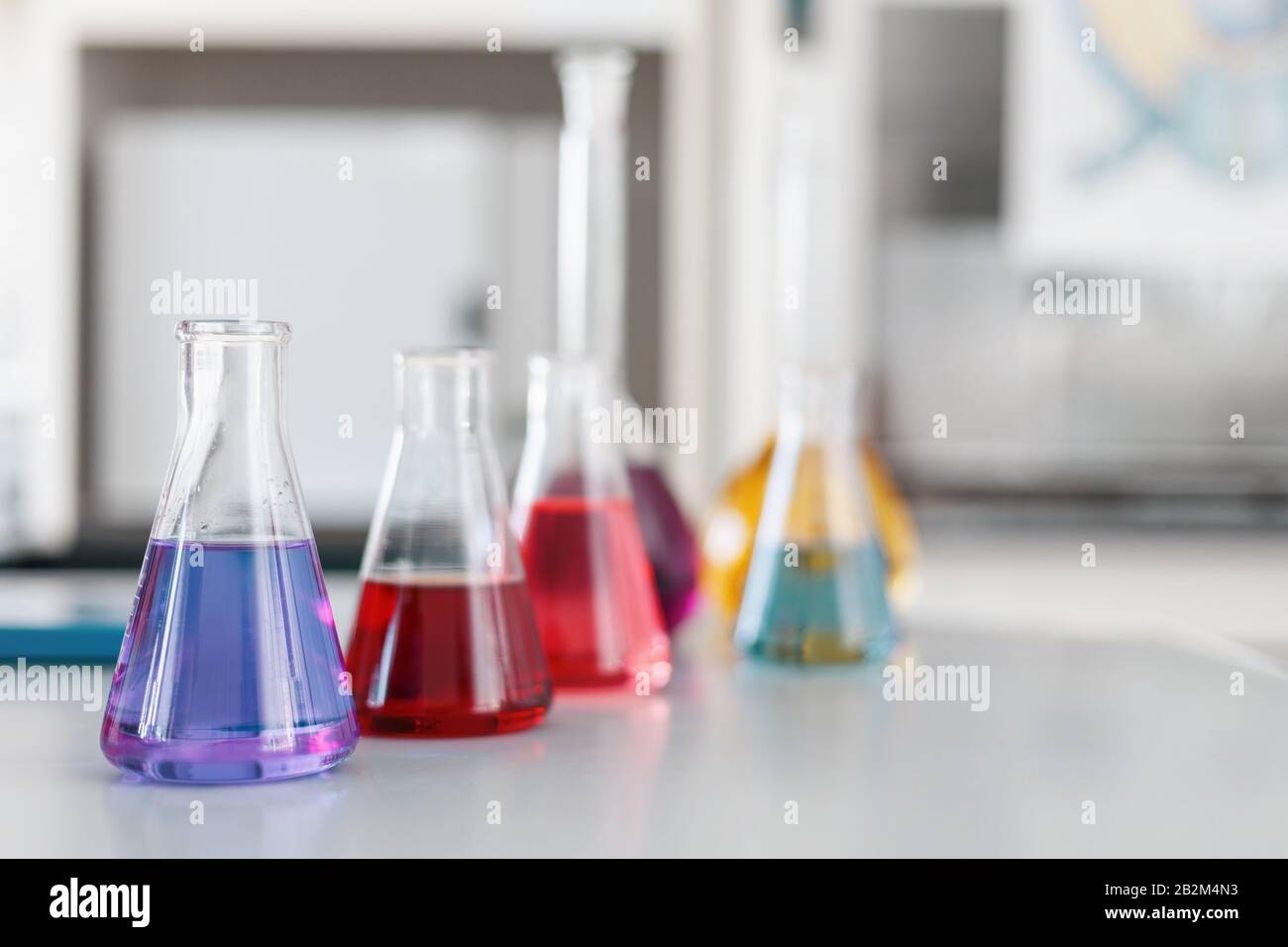 Chemical laboratory flask with blue purple-pink liquid stand on the ...