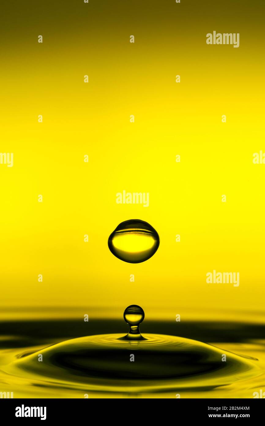 Water Drop Bouncing Back From The Surface Dragging Along A Small ...