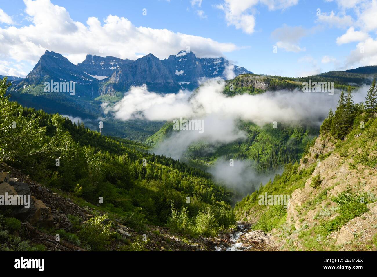 Above the clouds looking down into a valley in the Glacier National ...