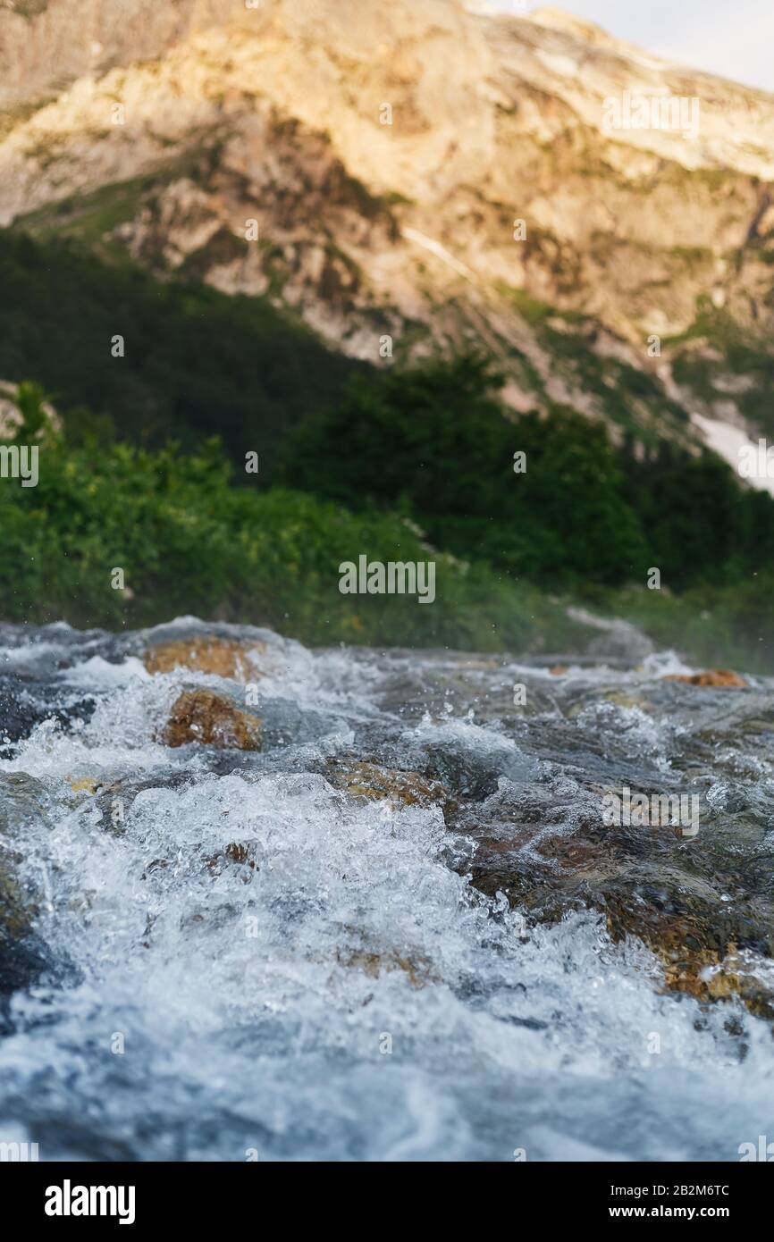 Texture of pure mountain stream against the background of mountains ...