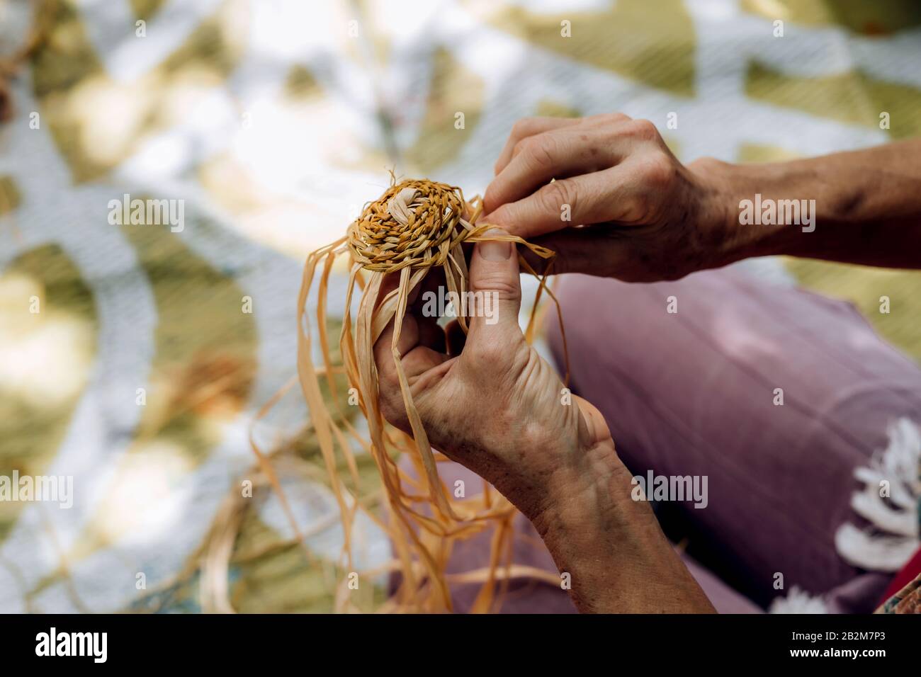 Female weaving basket on the craft workshop. Hands holding the ...
