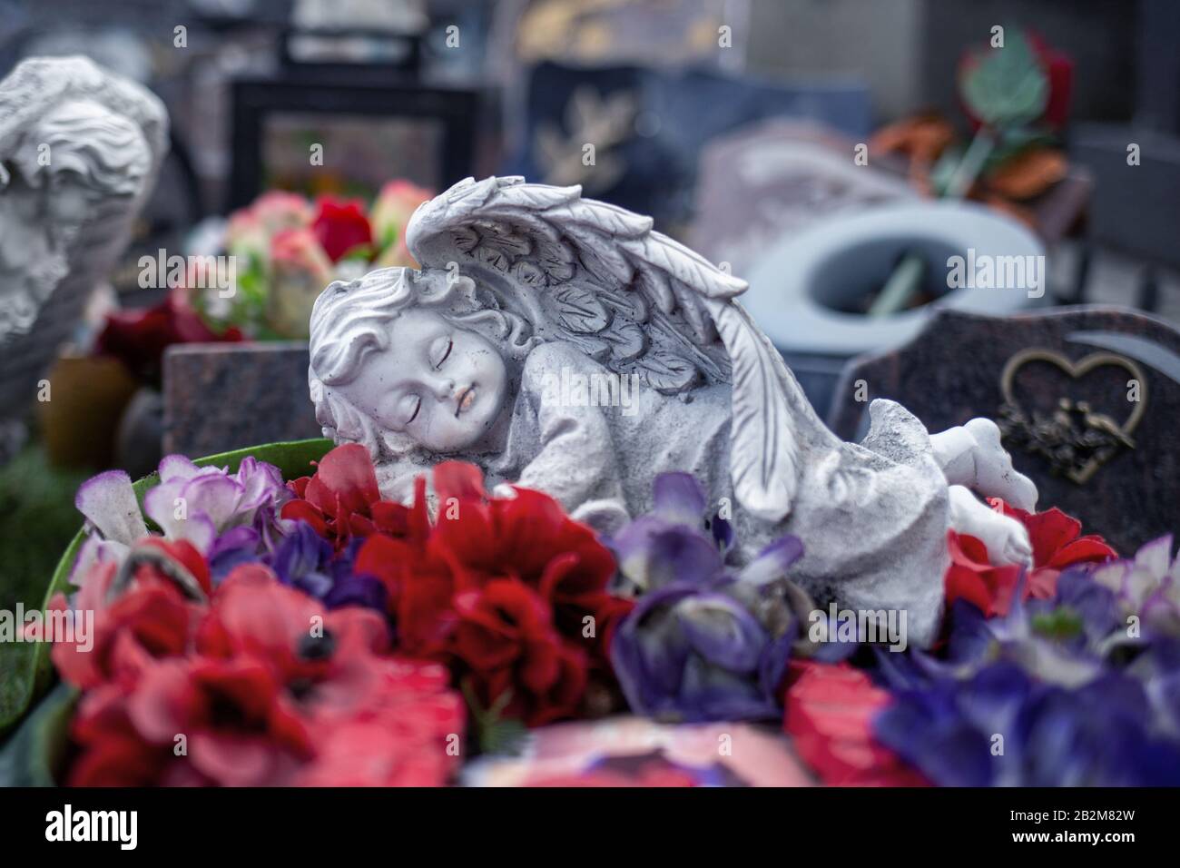 sleeping stoned angel at cemetery,grave angel statue Stock Photo - Alamy