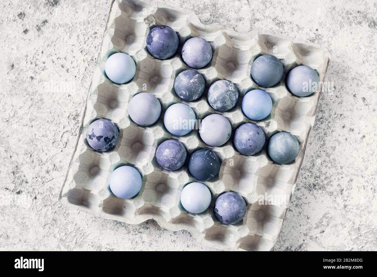 Blue Easter eggs with marble stone effect on grey concrete background ...