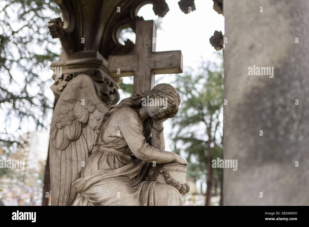 Statue of a sleeping angel in an old cemetery, ancient traditional ...