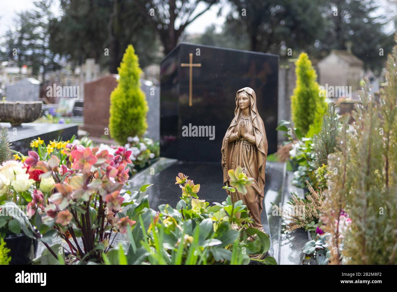 Virgin Mary at cemetery, graveyard background, tombstone Stock Photo ...
