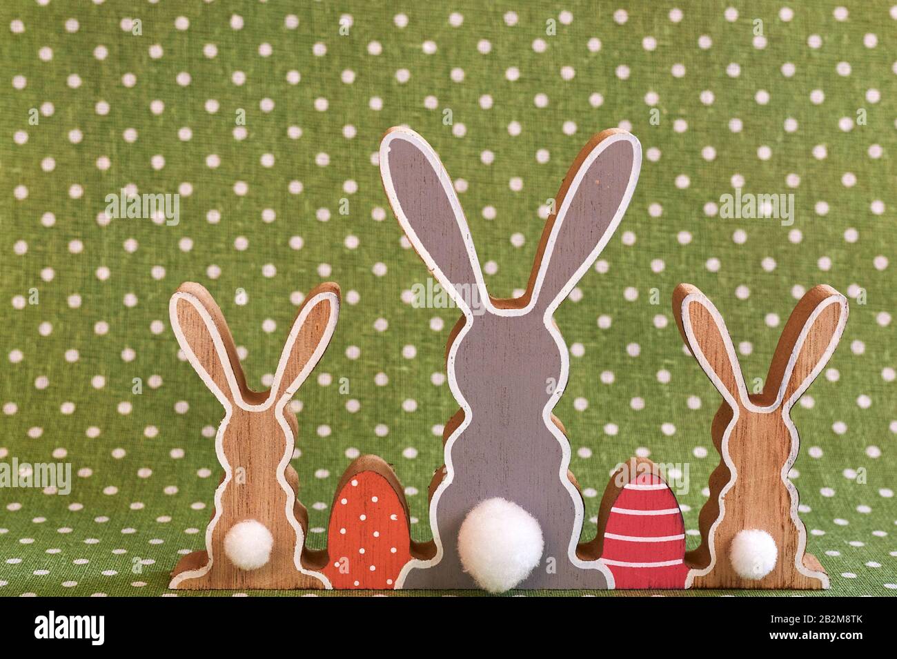 Three wooden Easter bunnies from behind with painted decoration Stock ...