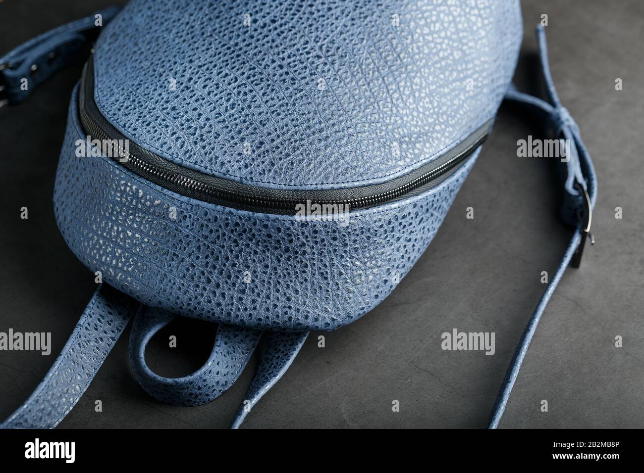 Blue backpack made of genuine leather on a dark background, handmade ...
