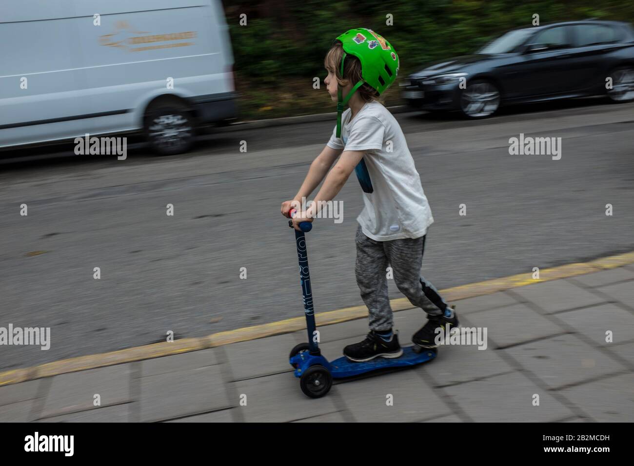 A young boy on a kick-bike in the Stockholm district of SoFo Stock ...