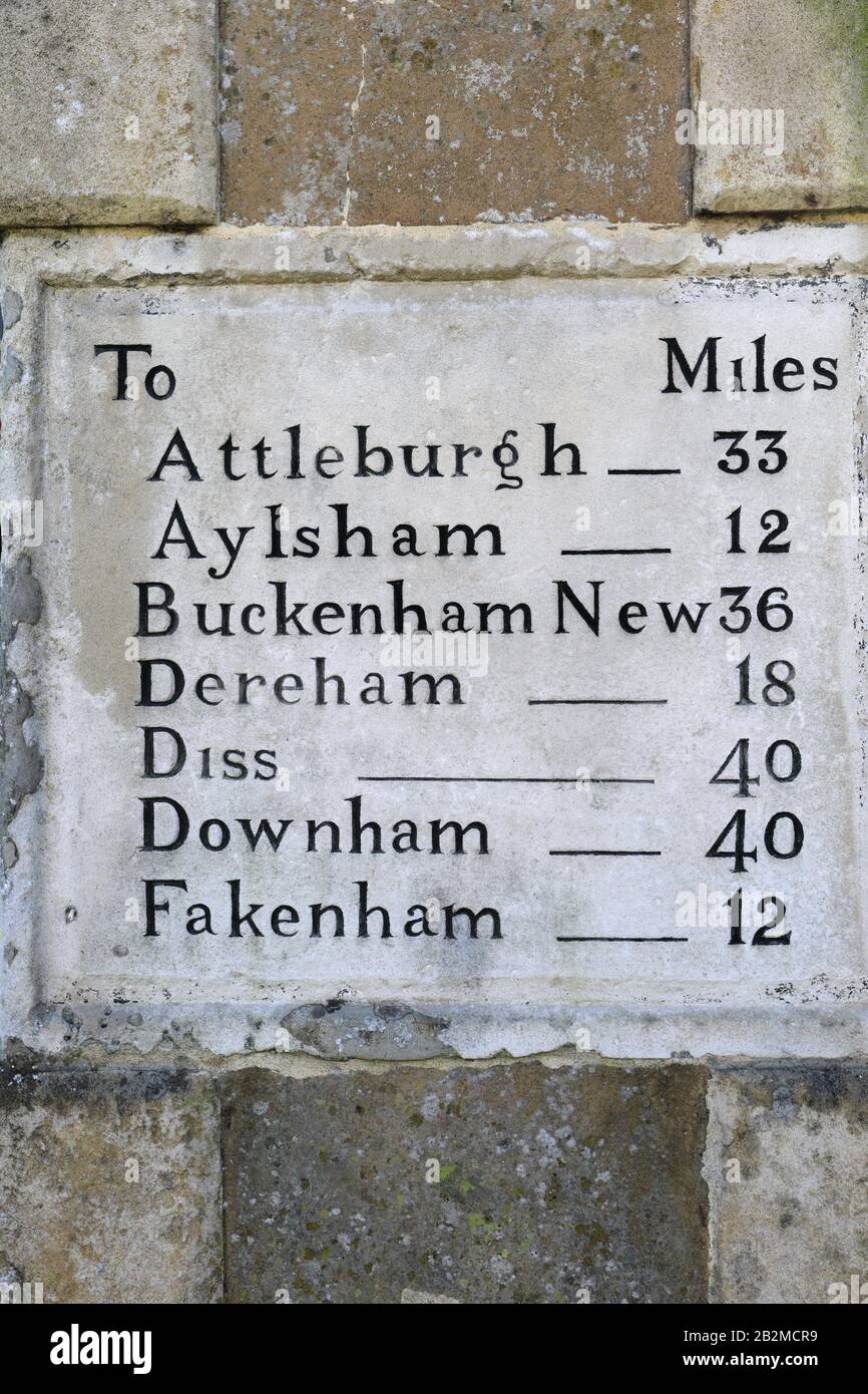 Ornate stone road sign, Holt town, Norfolk, England, UK Stock Photo - Alamy