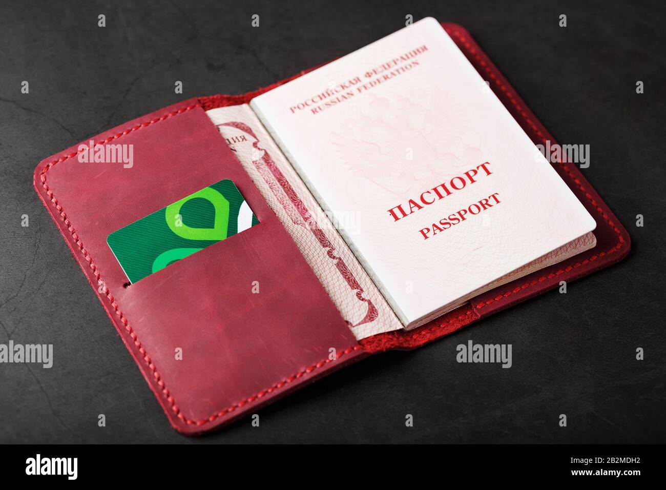 Red handmade passport cover made of genuine leather on a dark ...