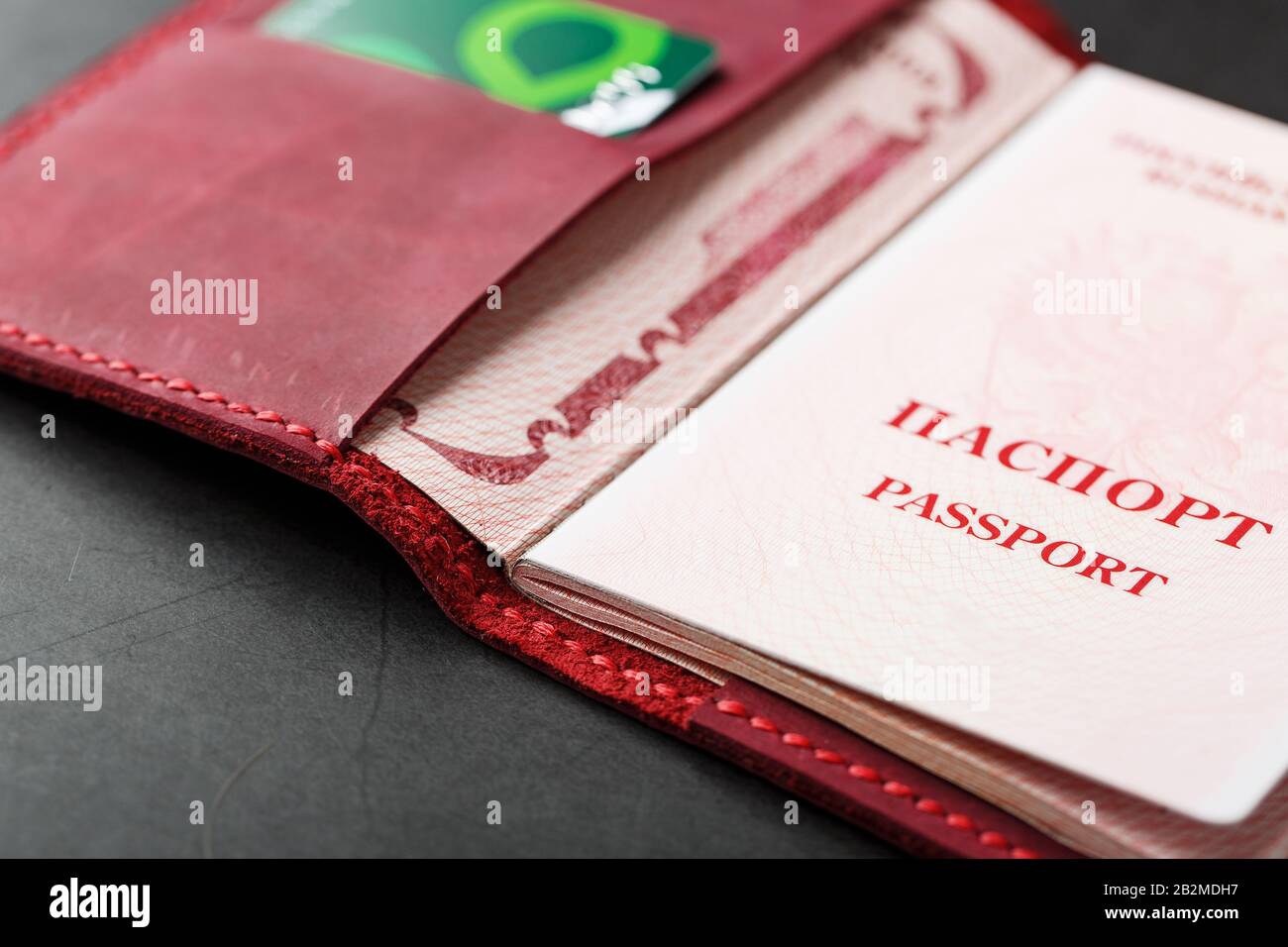 Red handmade passport cover made of genuine leather on a dark ...