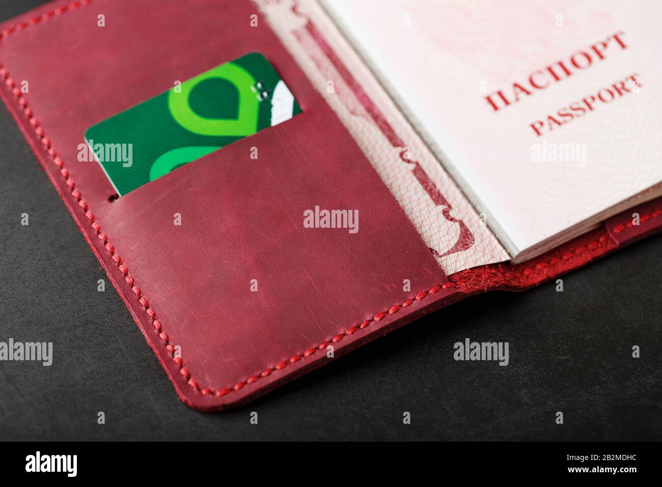 Red handmade passport cover made of genuine leather on a dark ...