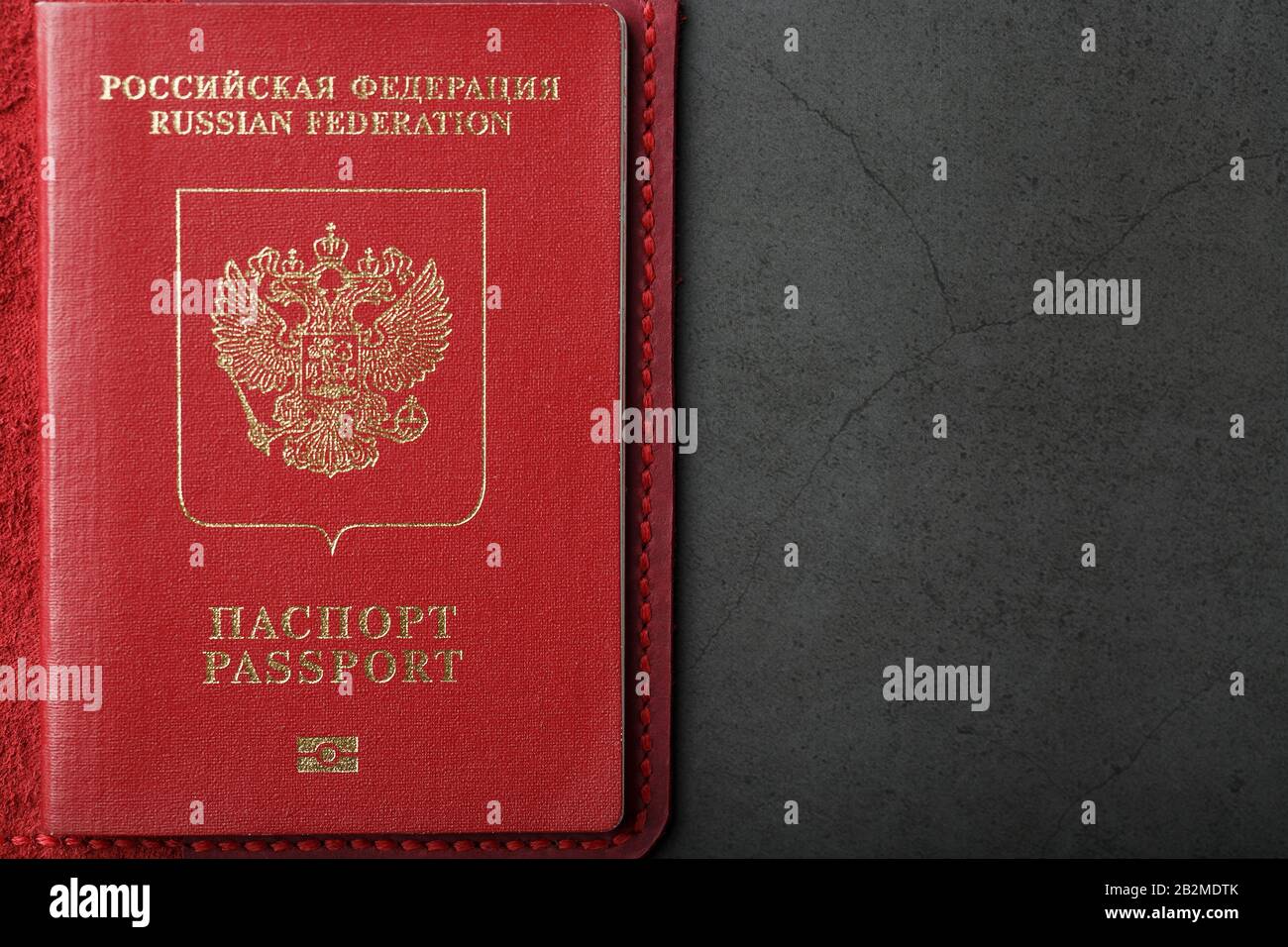 Red passport cover made of genuine leather handmade on a dark ...