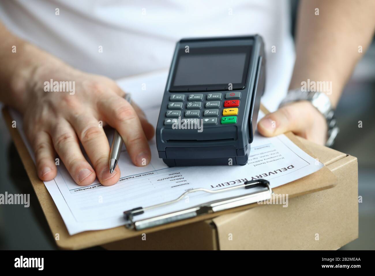 Man holds parcel delivery document and terminal Stock Photo - Alamy