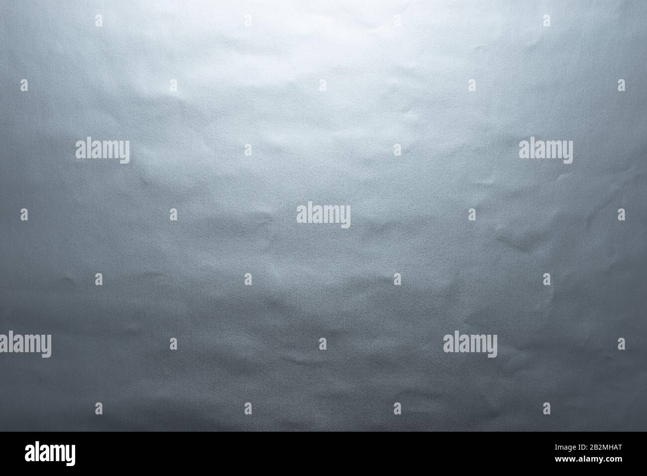 Silver background of real silver paper, illuminated by a soft light ...