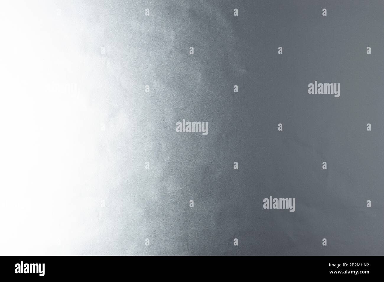 Silver background of real silver paper, illuminated by a soft light ...